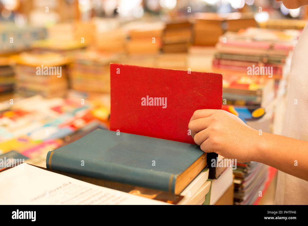 young boy reading a book in a bookstore Stock Photo - Alamy