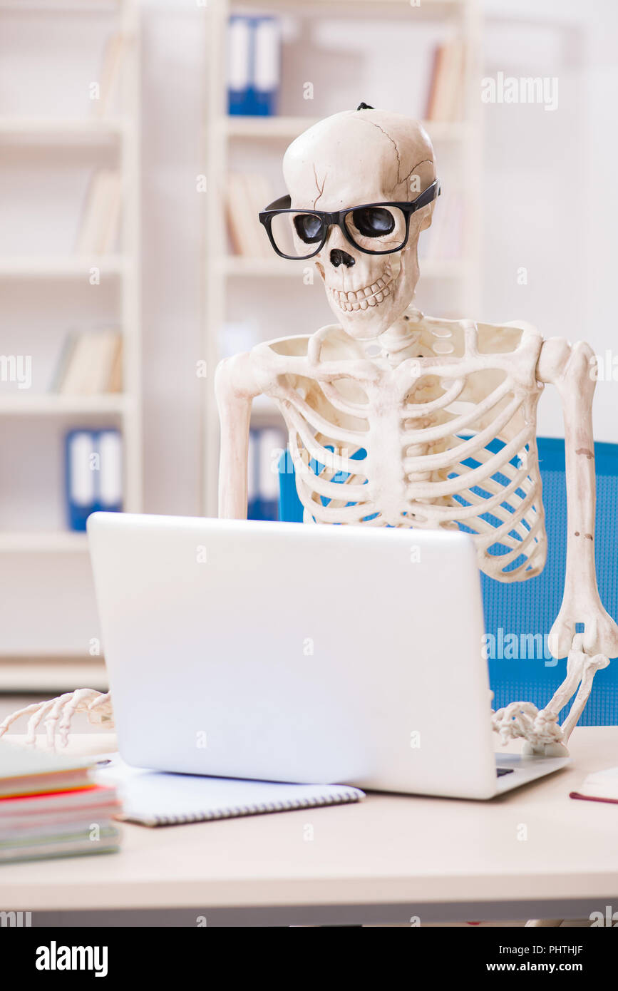 Skeleton businessman working in the office Stock Photo - Alamy