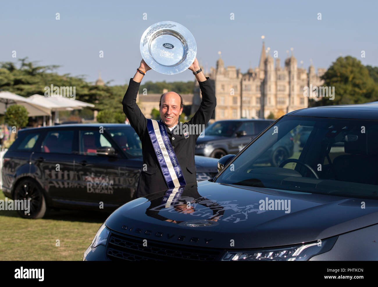 New Zealand's Tim Price poses with his trophy on a Land Rover Discovery ...