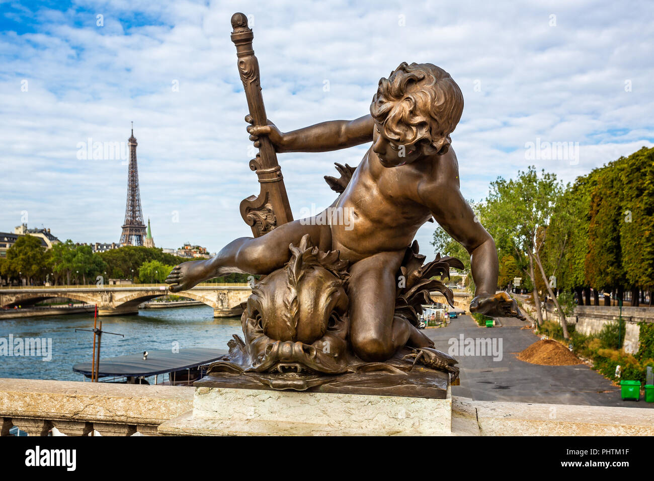 Statue of cupid with sea monster on the Alexander III Bridge with the ...