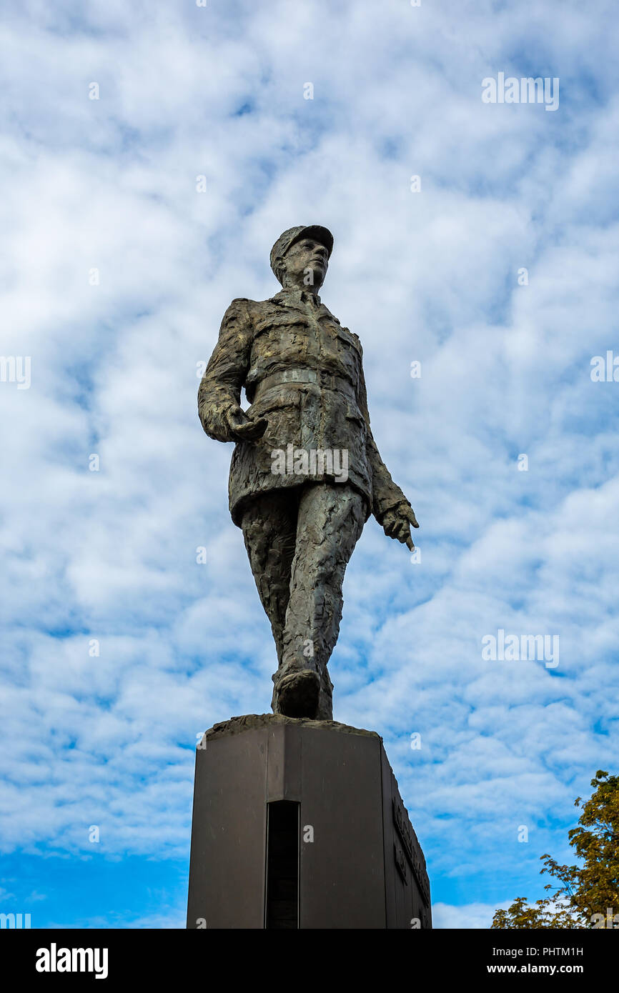 Bronze Statue of Charles de Gaulle against a blue sky in the Place ...