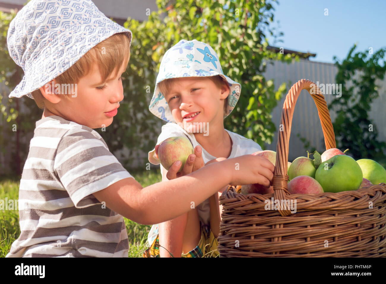 Two cute boys. Happy childhood concept. Children with fruits Stock ...