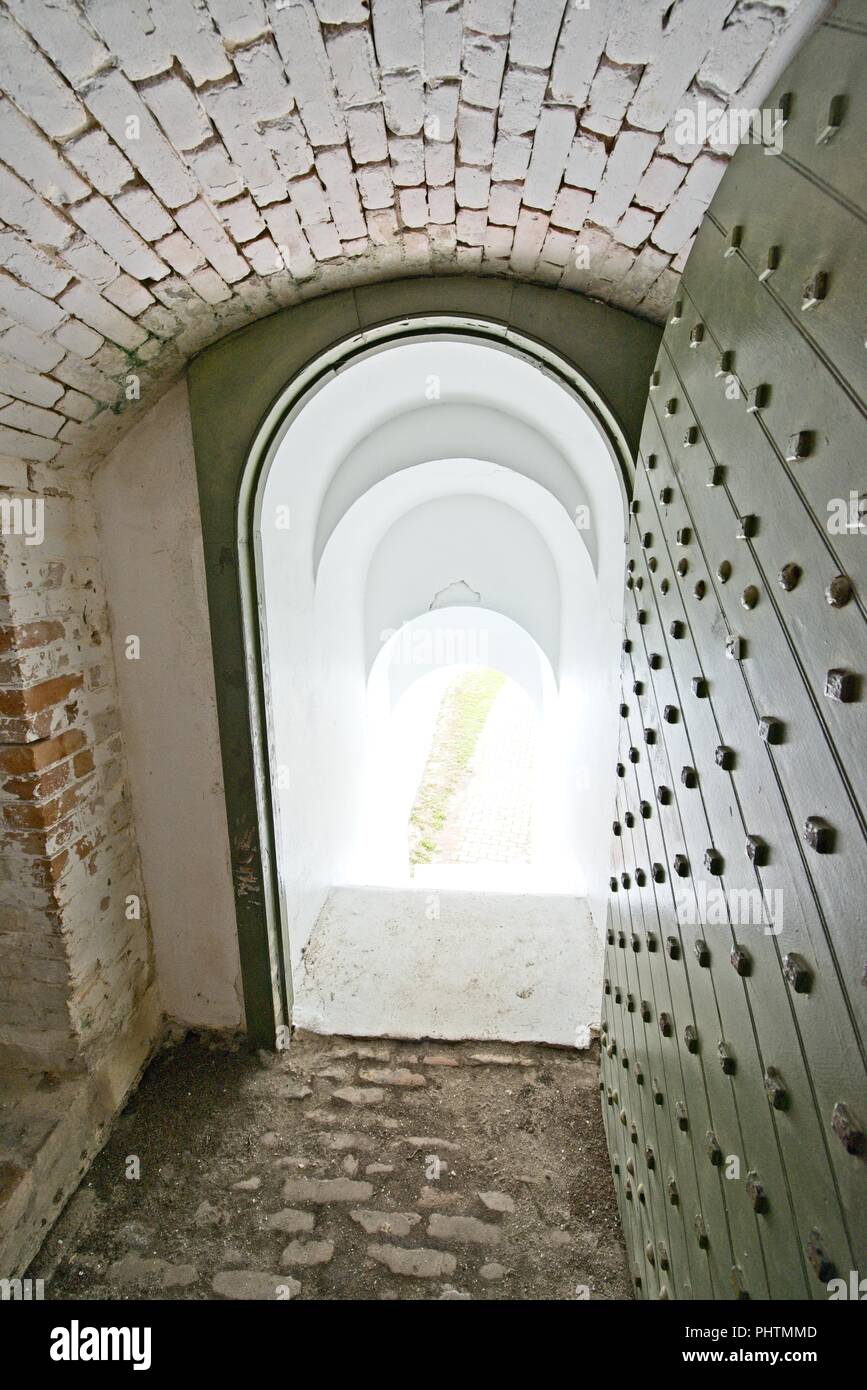 An arched exit door at an exit of a historic brick fortress located at ...