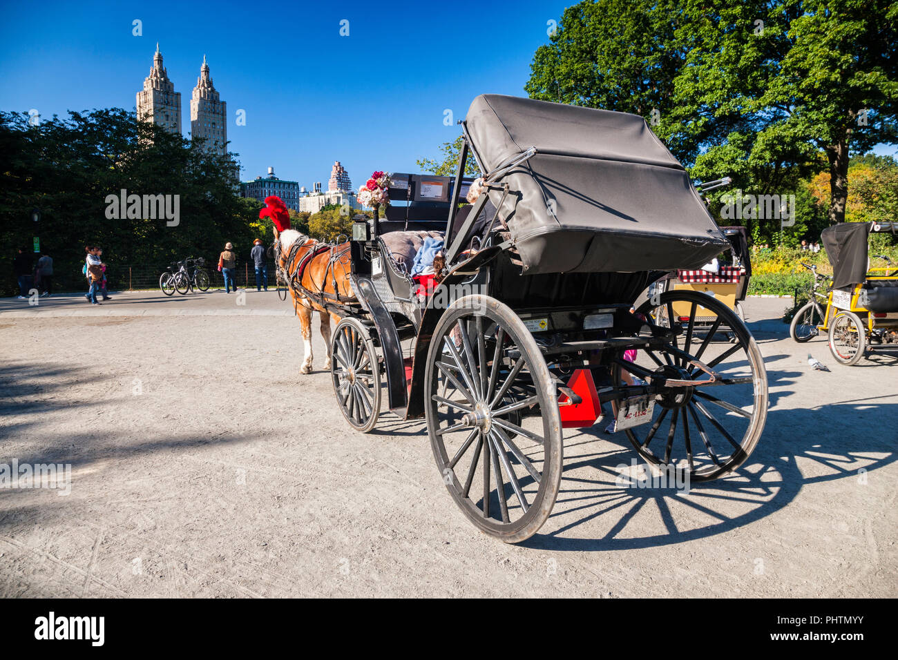 Central Park Carriage Rides and San Remo Towers on the back Stock Photo ...