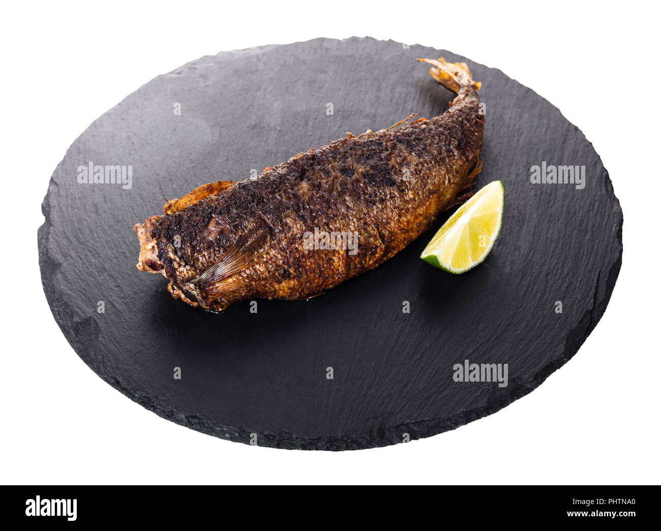 cooked fish and a slice of lime on white isolated background Stock ...