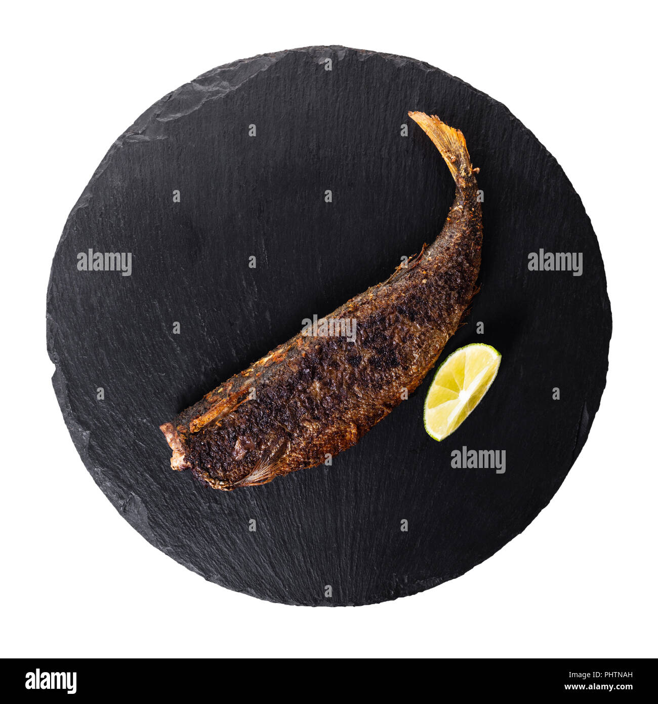 cooked fish and a slice of lime on white isolated background Stock ...