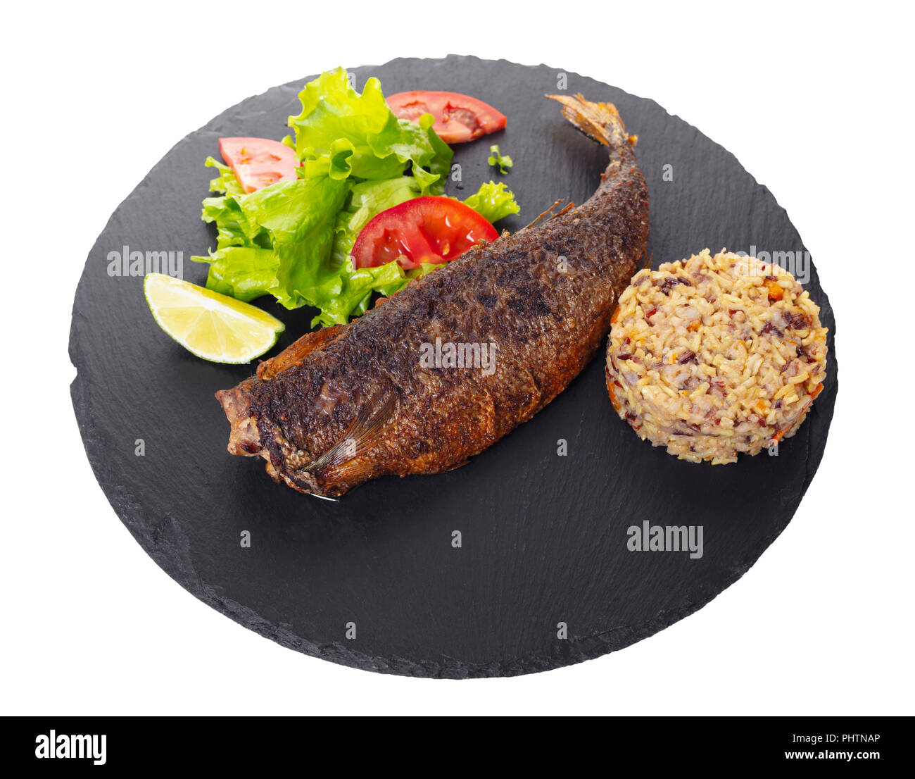 cooked fish with rice and vegetables on white isolated background Stock ...
