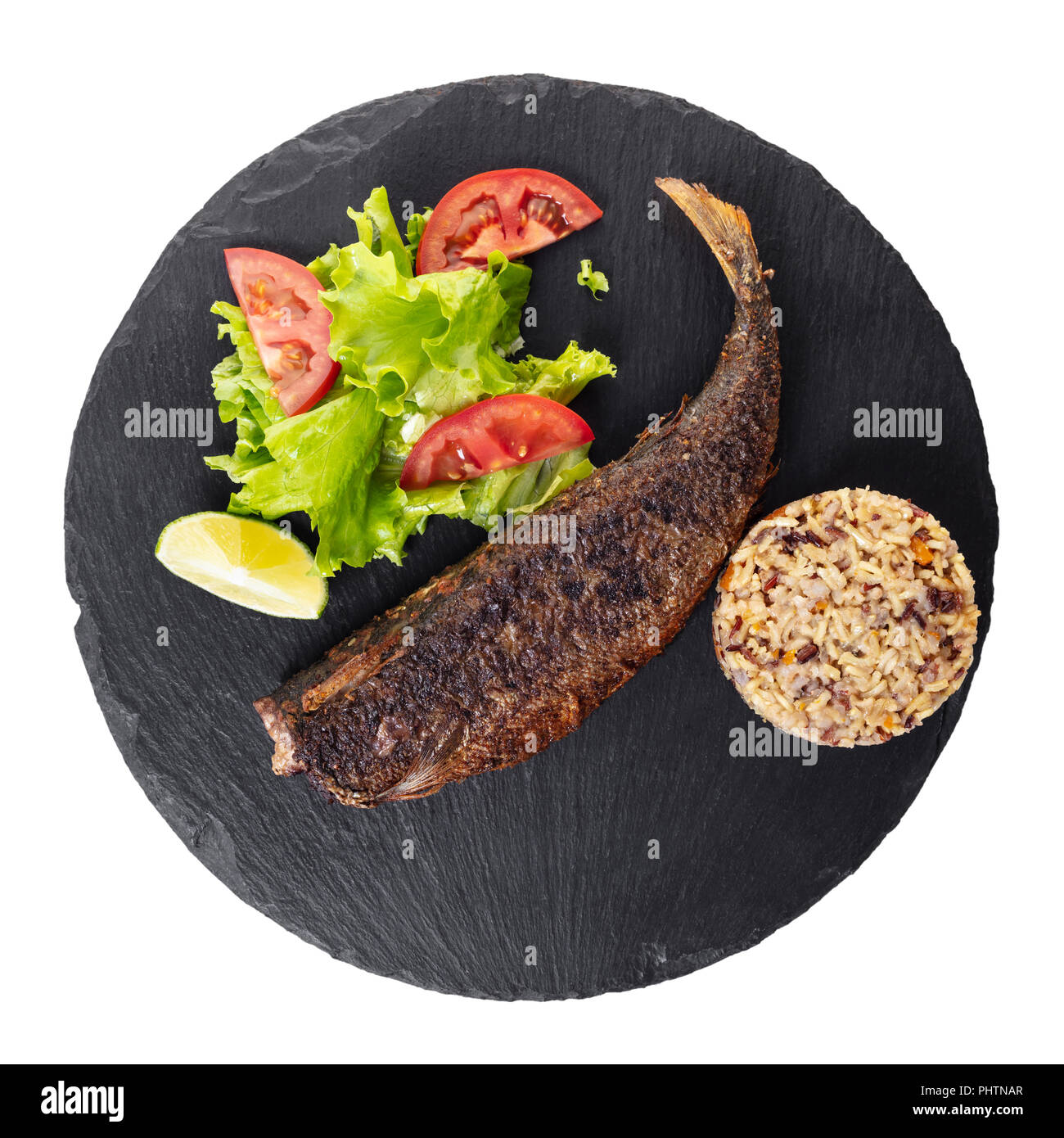 cooked fish with rice and vegetables on white isolated background Stock ...