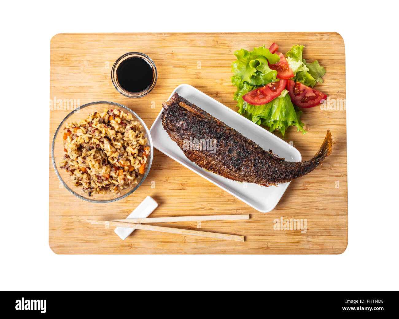 cooked fish with rice and vegetables on white isolated background Stock ...