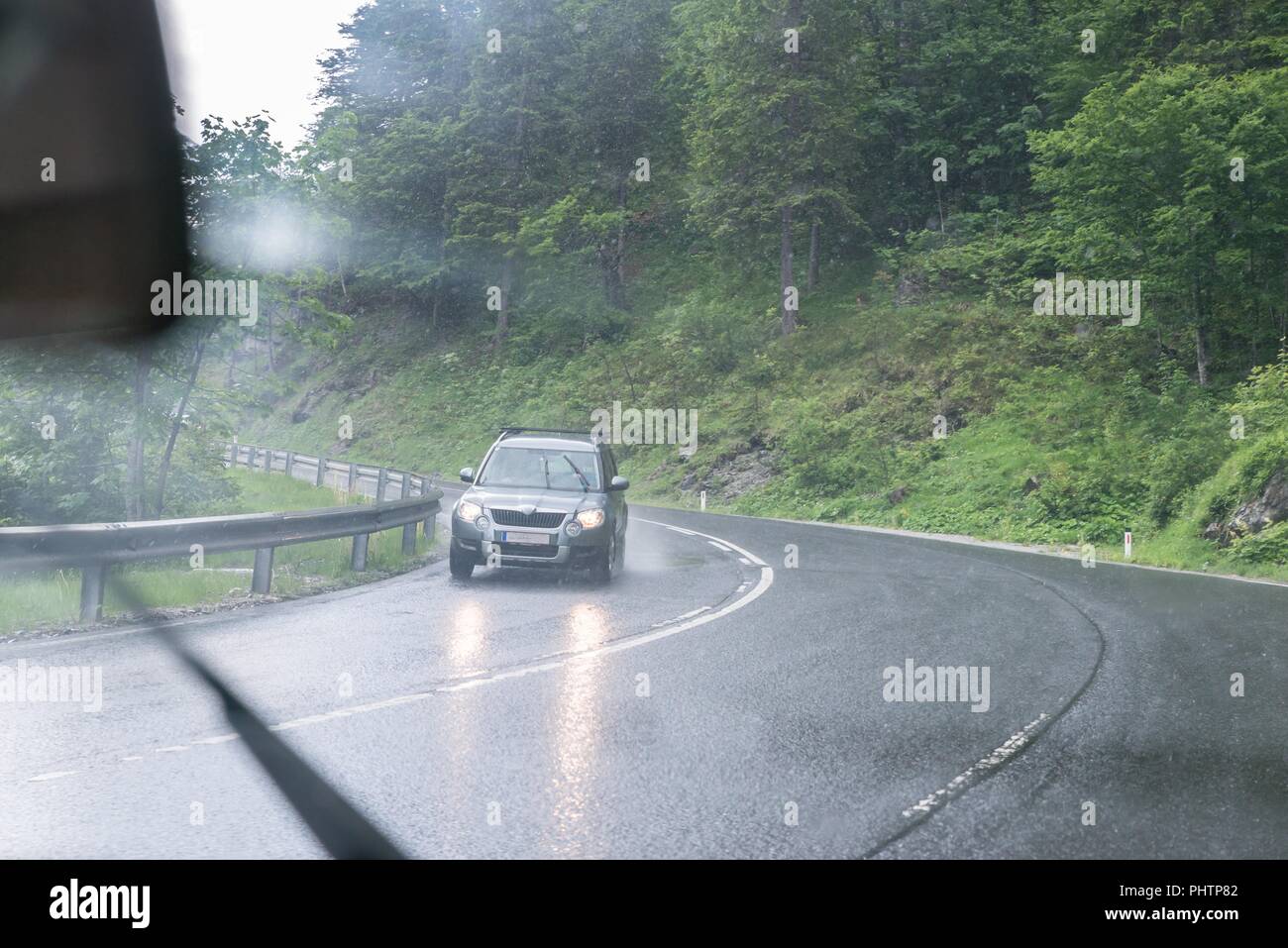 Rainy road surface and raindrops on a car windshield Stock Photo - Alamy