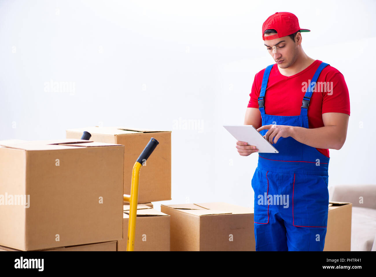 Contractor worker moving boxes during office move Stock Photo - Alamy