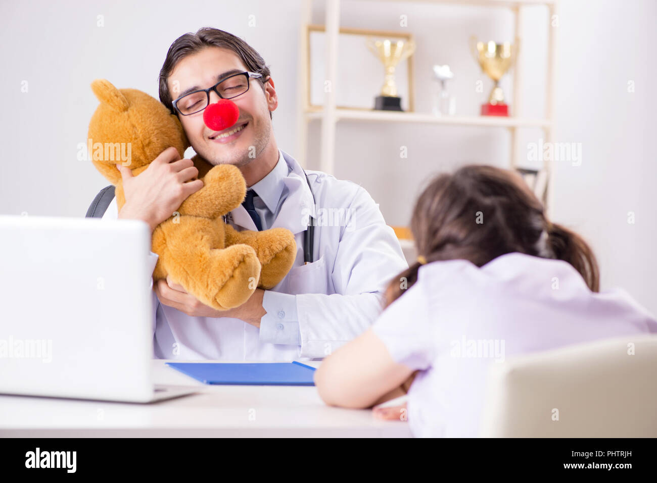 Funny pediatrician with little girl at regular check-up Stock Photo - Alamy