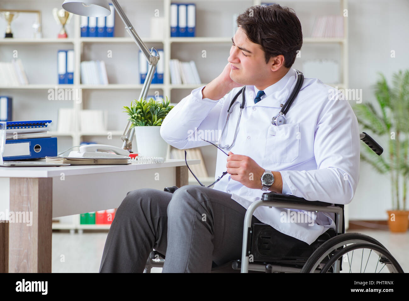 Disabled doctor on wheelchair working in hospital Stock Photo - Alamy