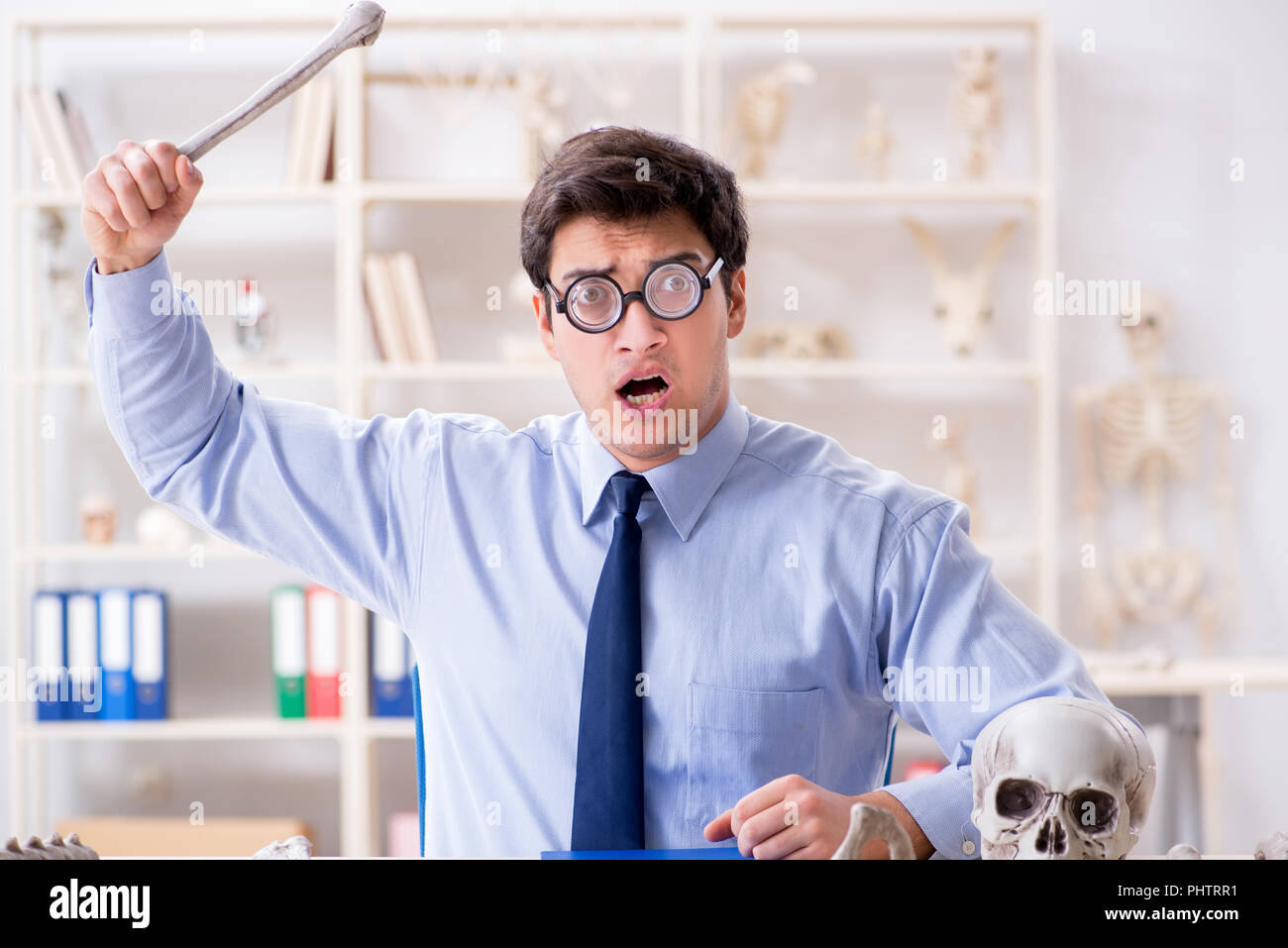Funny crazy professor studying human skeleton Stock Photo - Alamy