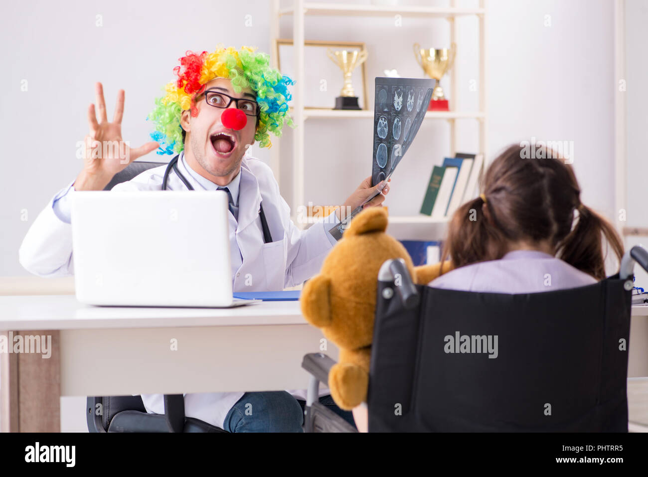 Funny pediatrician with little girl at regular check-up Stock Photo - Alamy