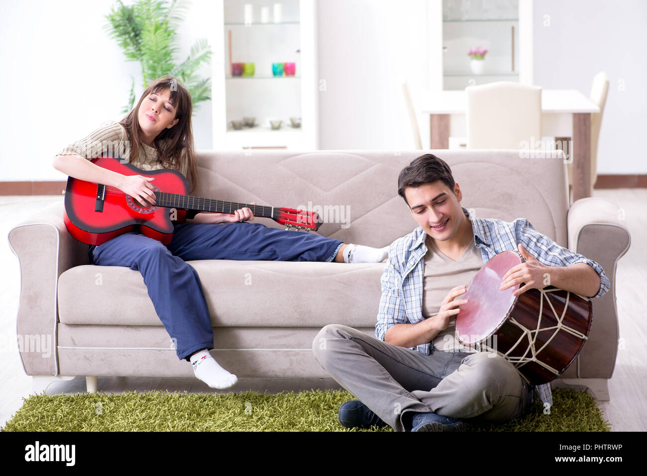 Young family singing and playing music at home Stock Photo - Alamy