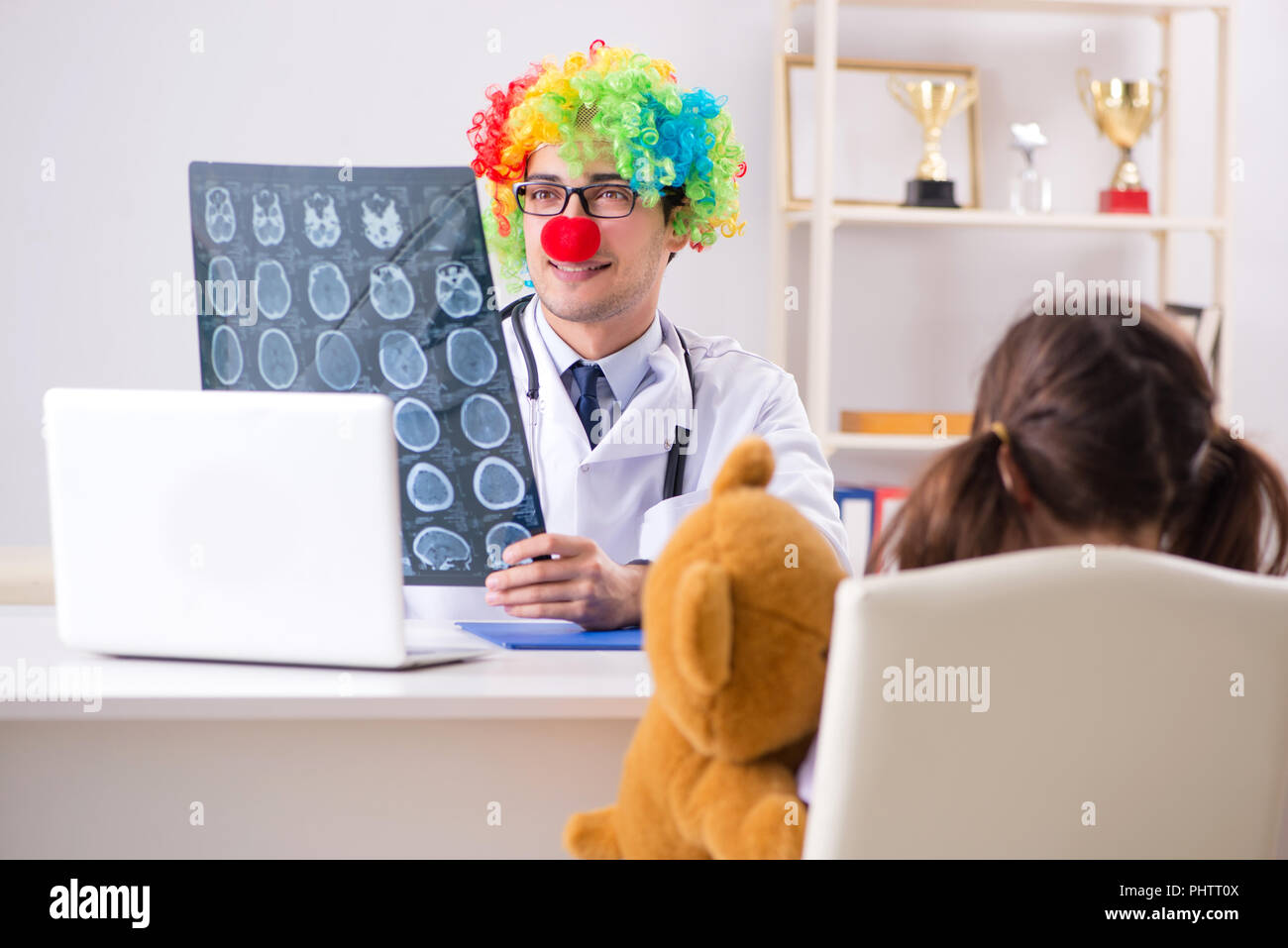 Funny pediatrician with little girl at regular check-up Stock Photo - Alamy