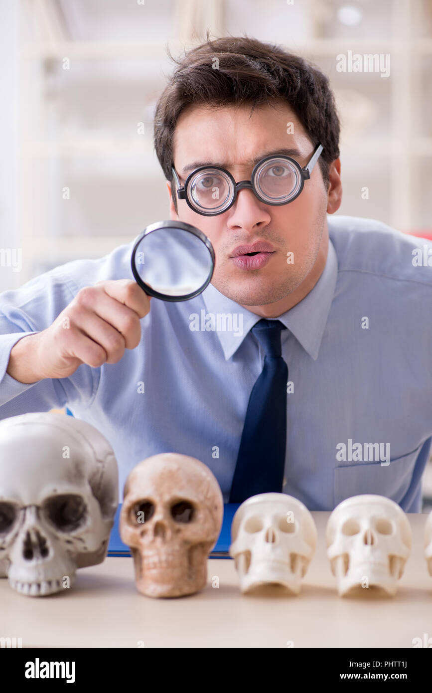 Funny crazy professor studying human skeleton Stock Photo - Alamy