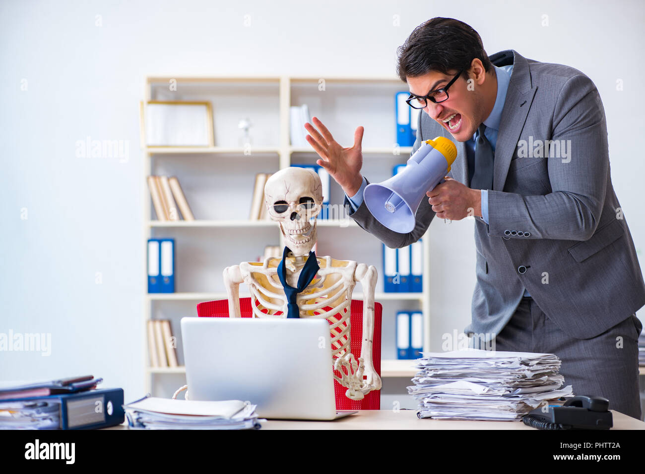 Angry boss yelling at his skeleton employee Stock Photo - Alamy