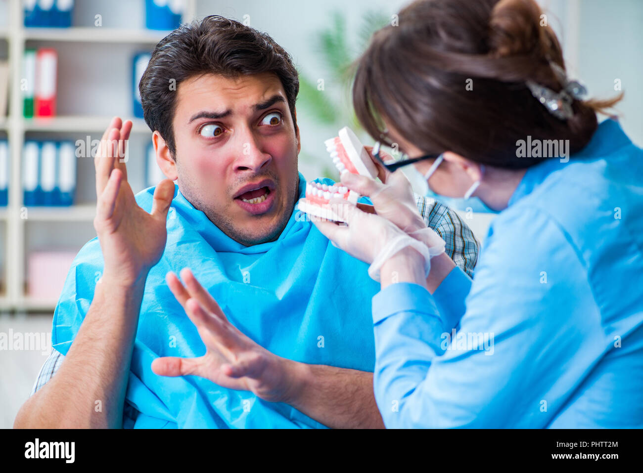 Patient afraid of dentist during doctor visit Stock Photo - Alamy