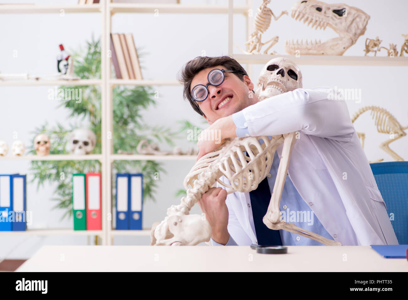 Crazy professor studying human skeleton Stock Photo - Alamy