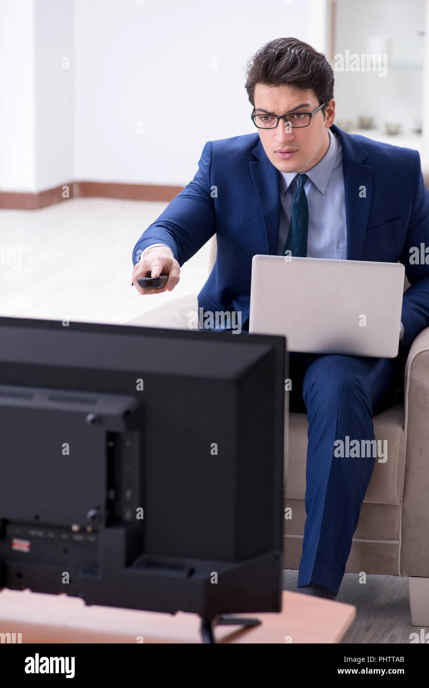 Businessman watching tv in the office Stock Photo - Alamy