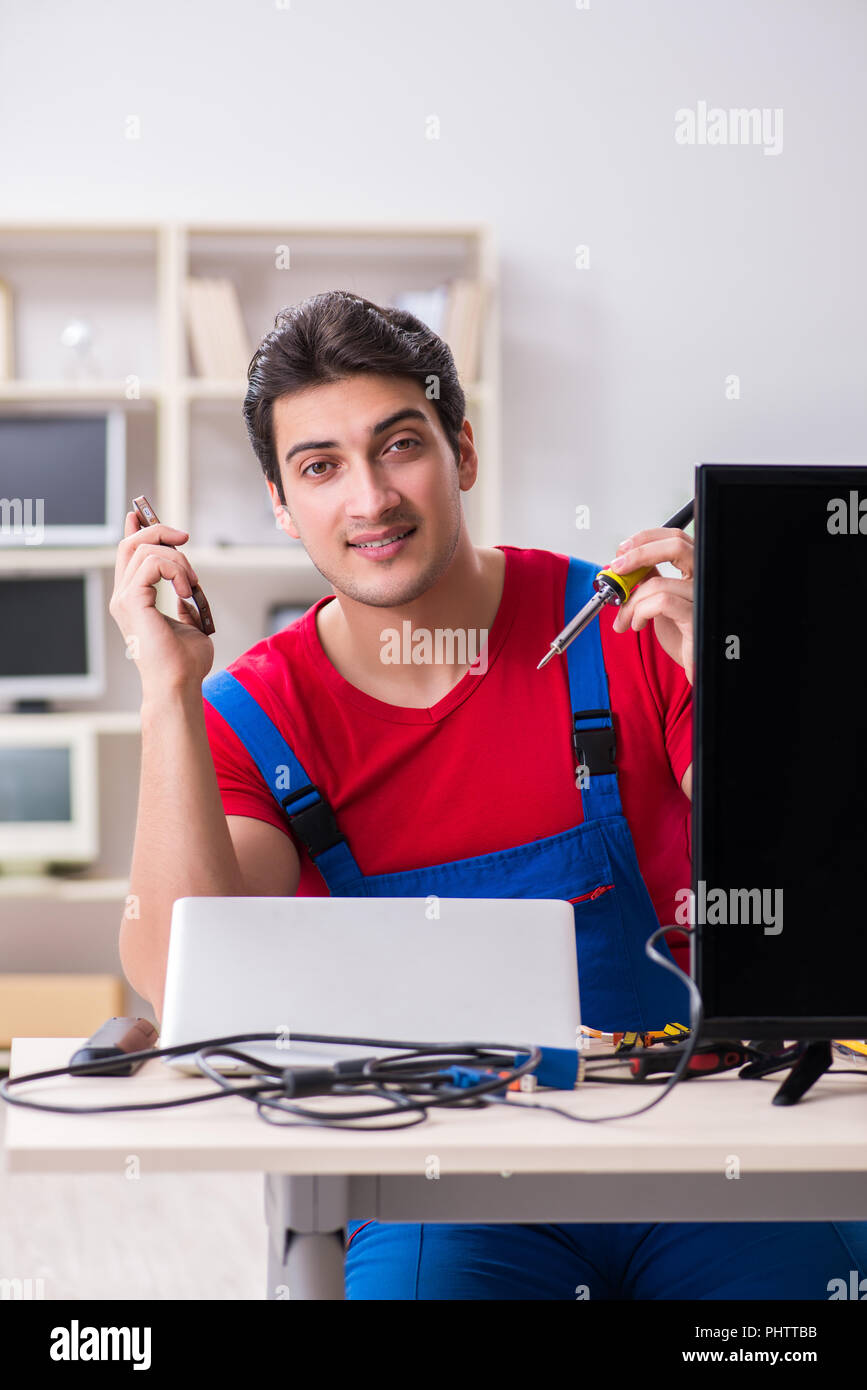 Professional repair engineer repairing broken tv Stock Photo - Alamy