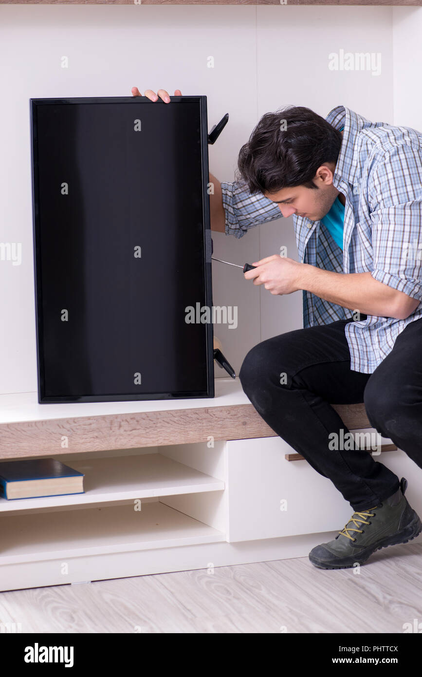 Man repairing broken tv at home Stock Photo - Alamy
