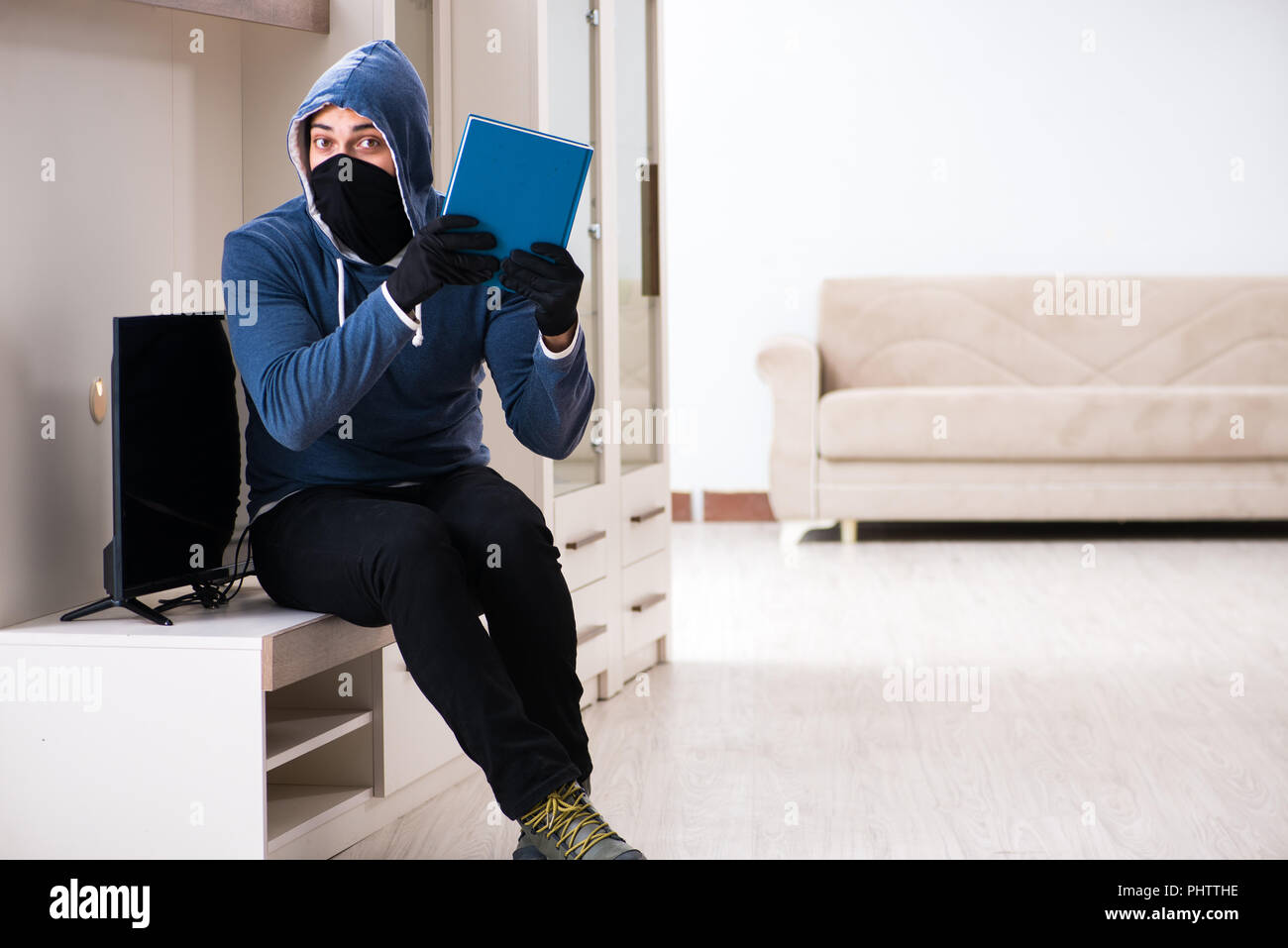 Man burglar stealing tv set from house hi-res stock photography and ...