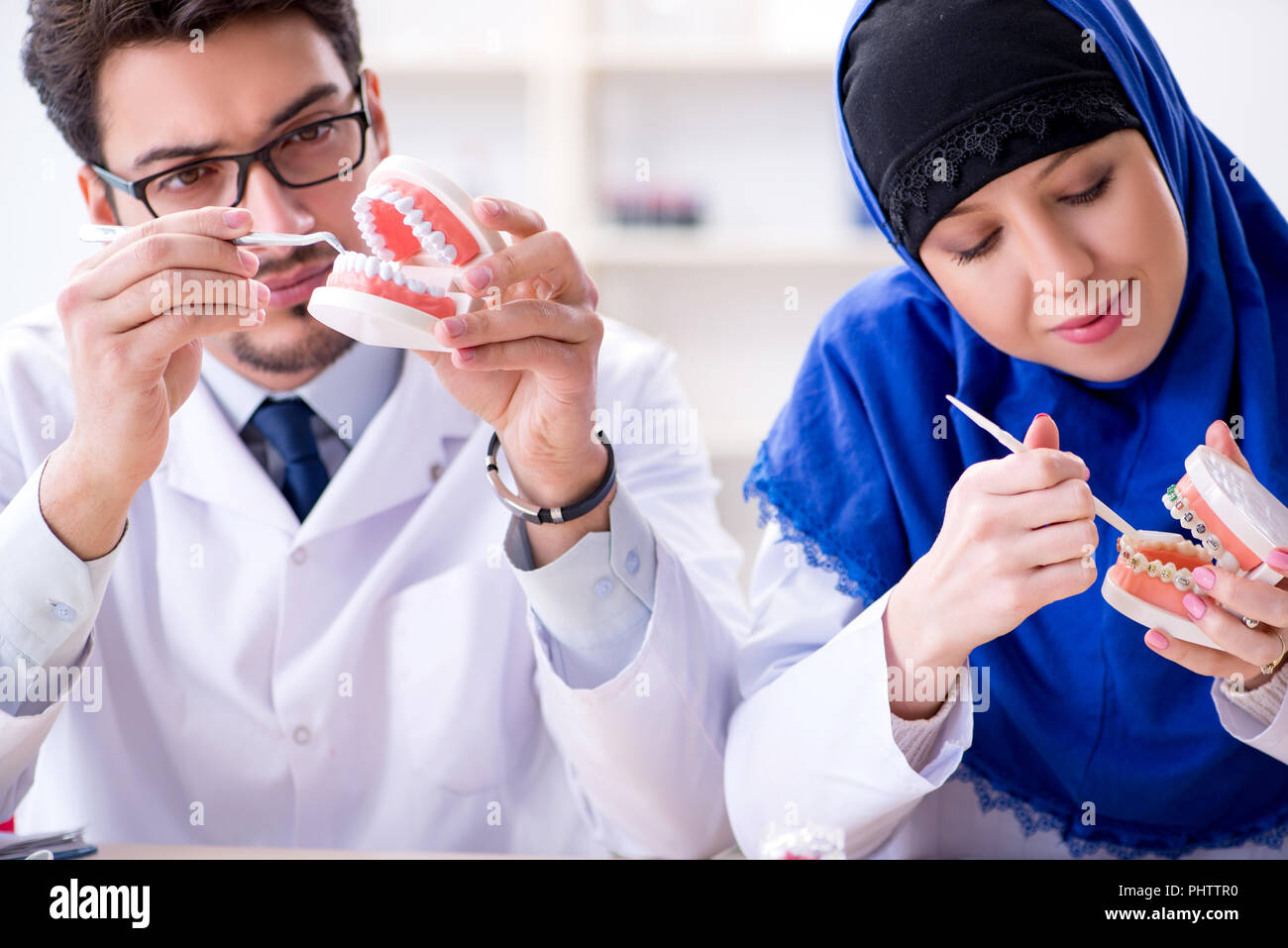 Dentist doctor and assistant working on new tooth implant Stock Photo ...