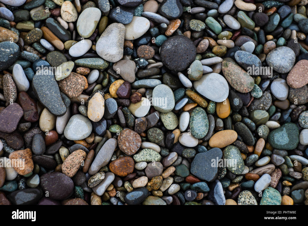 Seaside pebbles on a beach as a natural backdround Stock Photo - Alamy