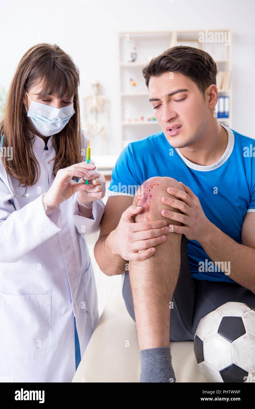 Football soccer player visiting doctor after injury Stock Photo - Alamy