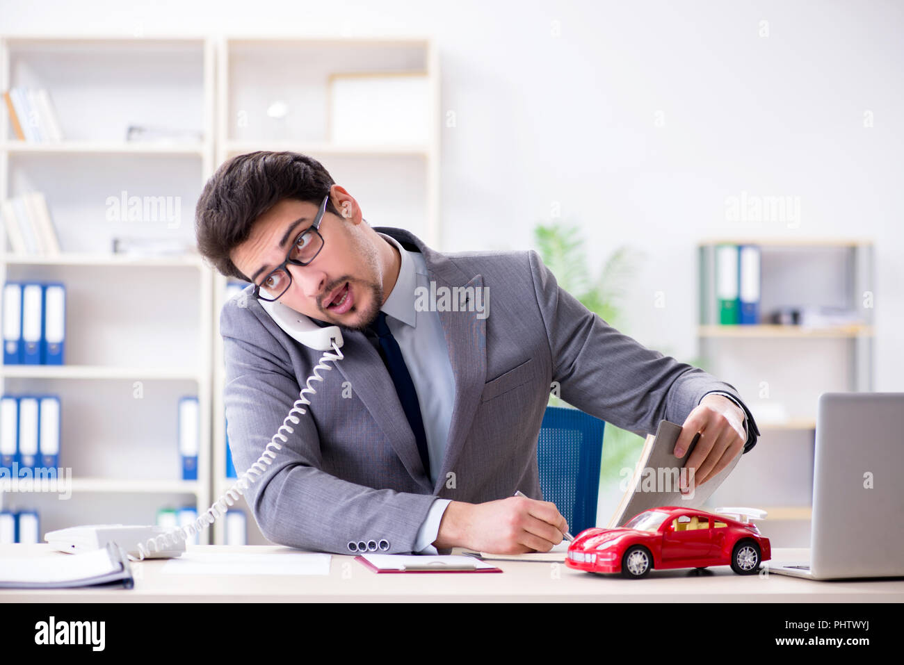 Agent offering car motor insurance Stock Photo - Alamy