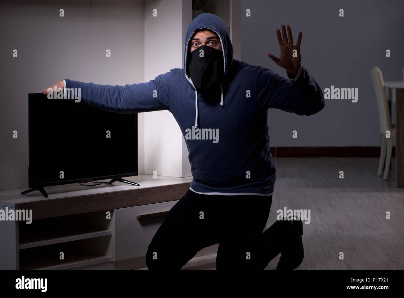 Burglar thief stealing tv from apartment house Stock Photo - Alamy