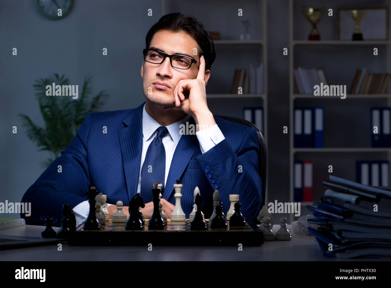 Businessman playing chess in strategy concept Stock Photo - Alamy