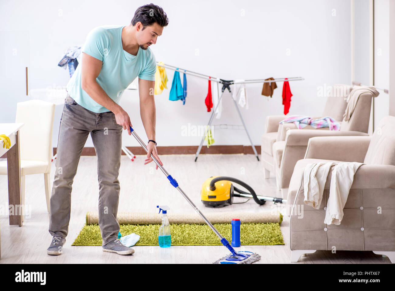 Young attractive man husband doing mopping at home Stock Photo - Alamy