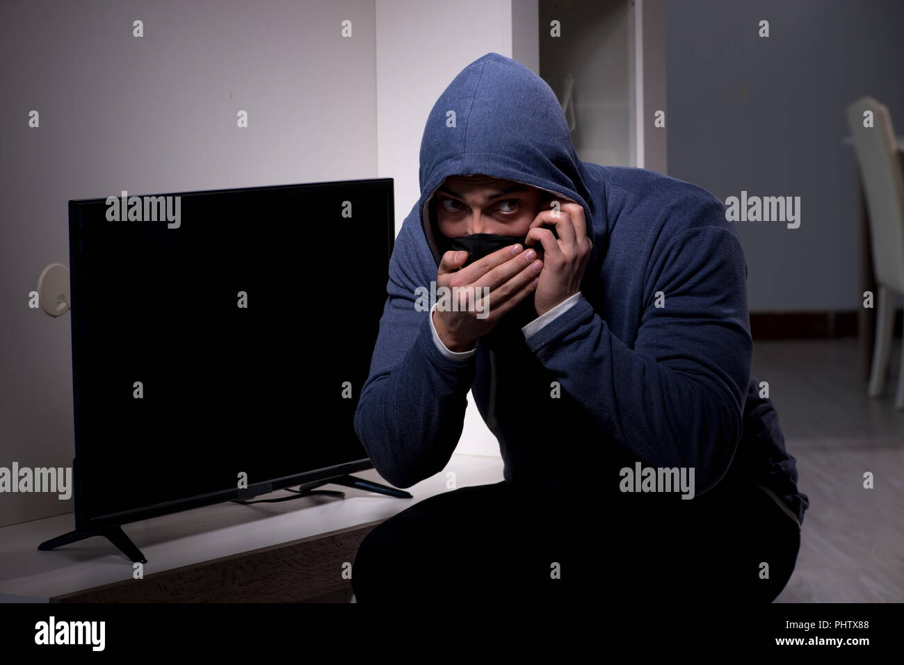 Burglar thief stealing tv from apartment house Stock Photo - Alamy