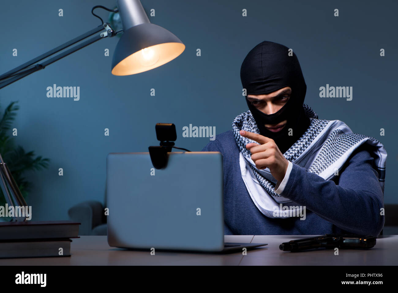 Hacker wearing balaclava mask hacking computer Stock Photo - Alamy