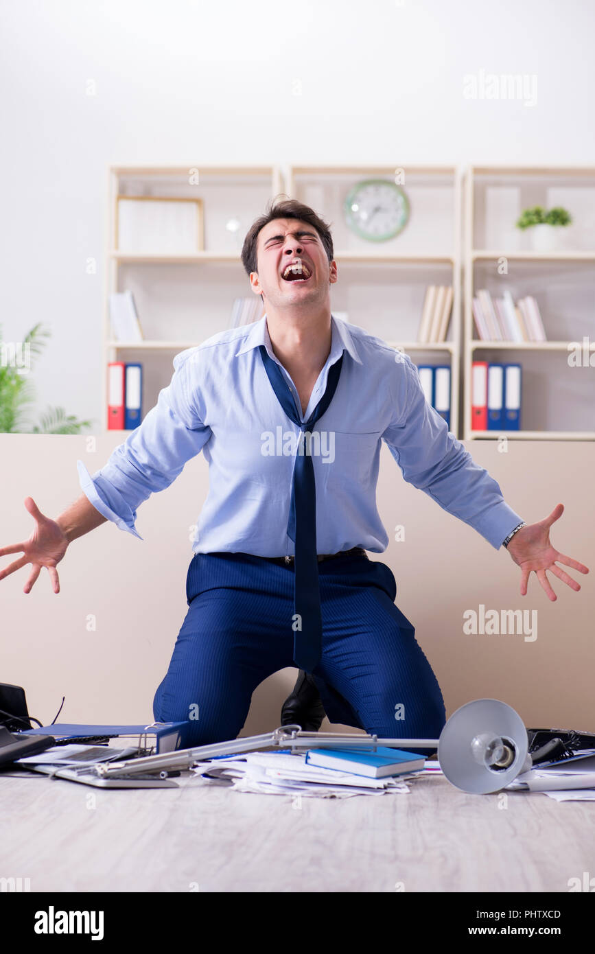 Angry businessman frustrated with too much work Stock Photo - Alamy