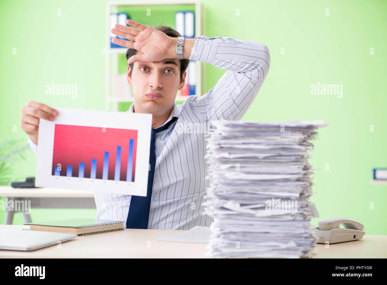 Businessman having problems with paperwork and workload Stock Photo - Alamy