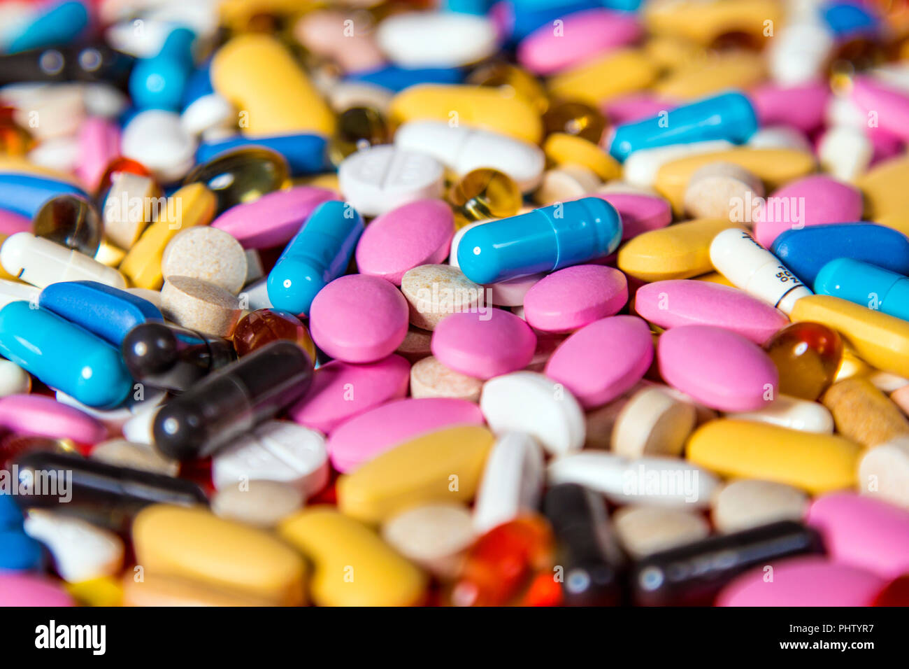 Pile of colourful pills, medication background Stock Photo - Alamy