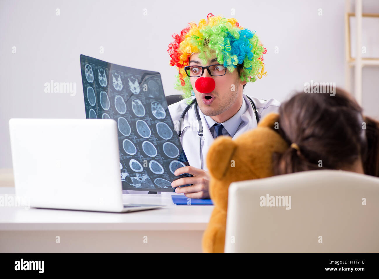 Funny pediatrician with little girl at regular check-up Stock Photo - Alamy