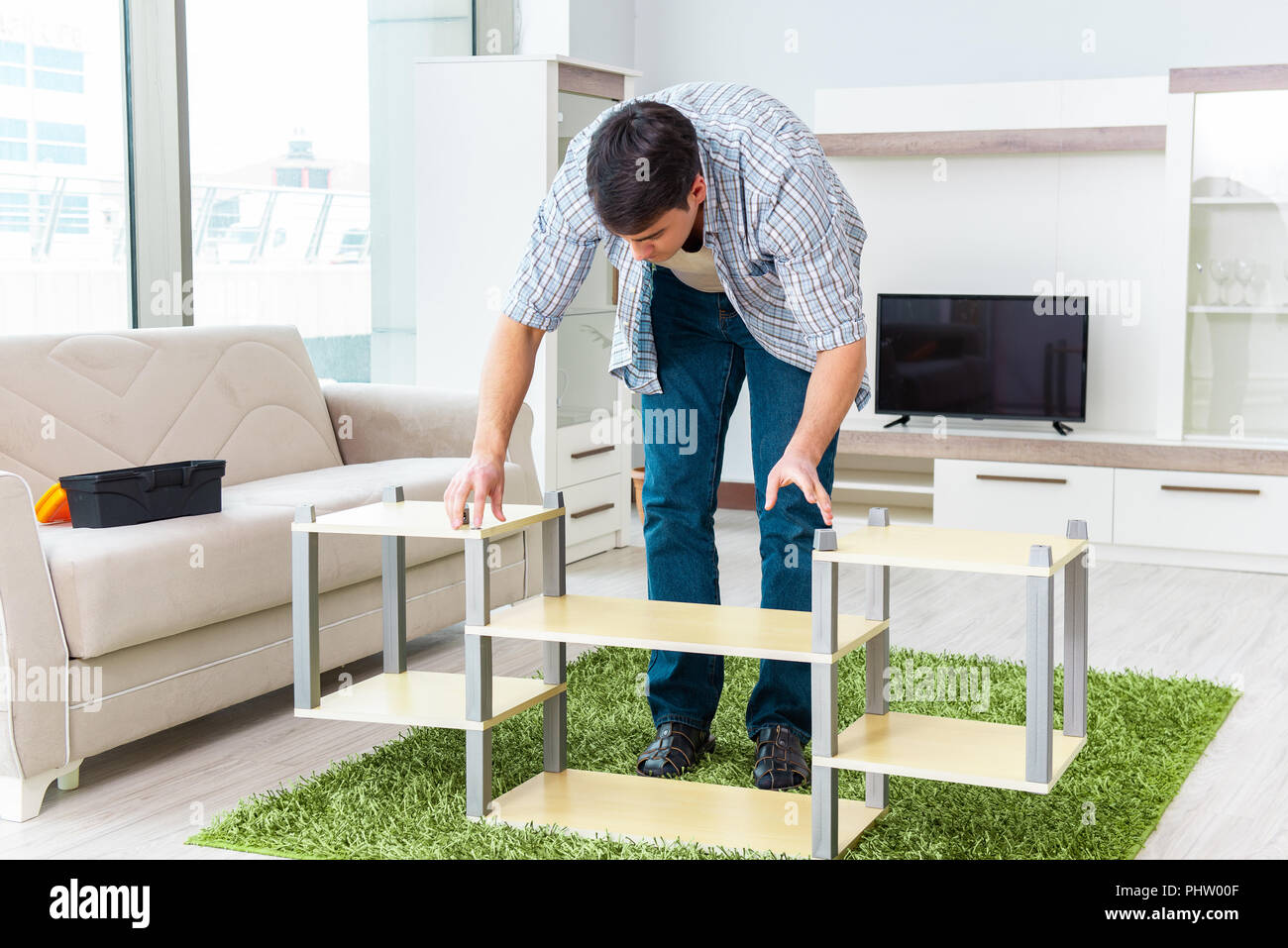 Man assembling furniture at home Stock Photo - Alamy