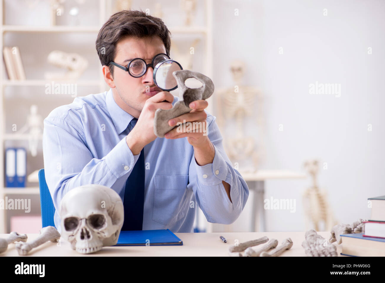 Funny crazy professor studying human skeleton Stock Photo - Alamy