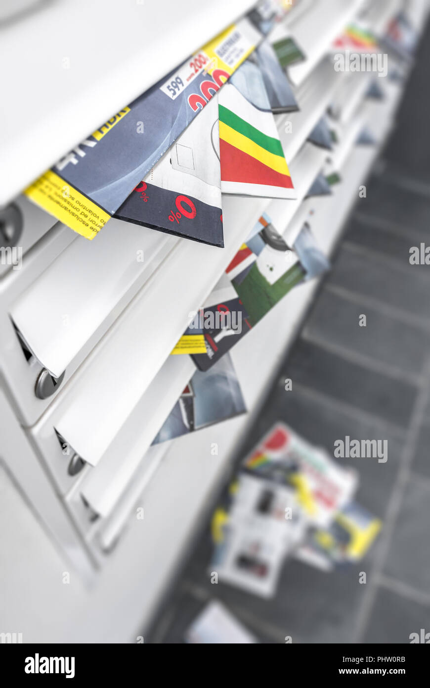 Modern metal mail boxes, overfull of leaflets Stock Photo - Alamy