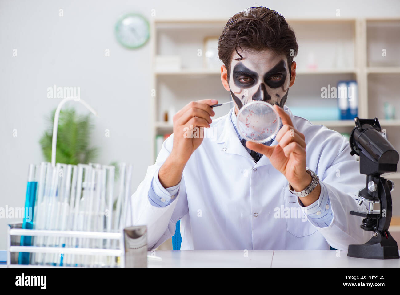 Scary monster doctor working in lab Stock Photo - Alamy