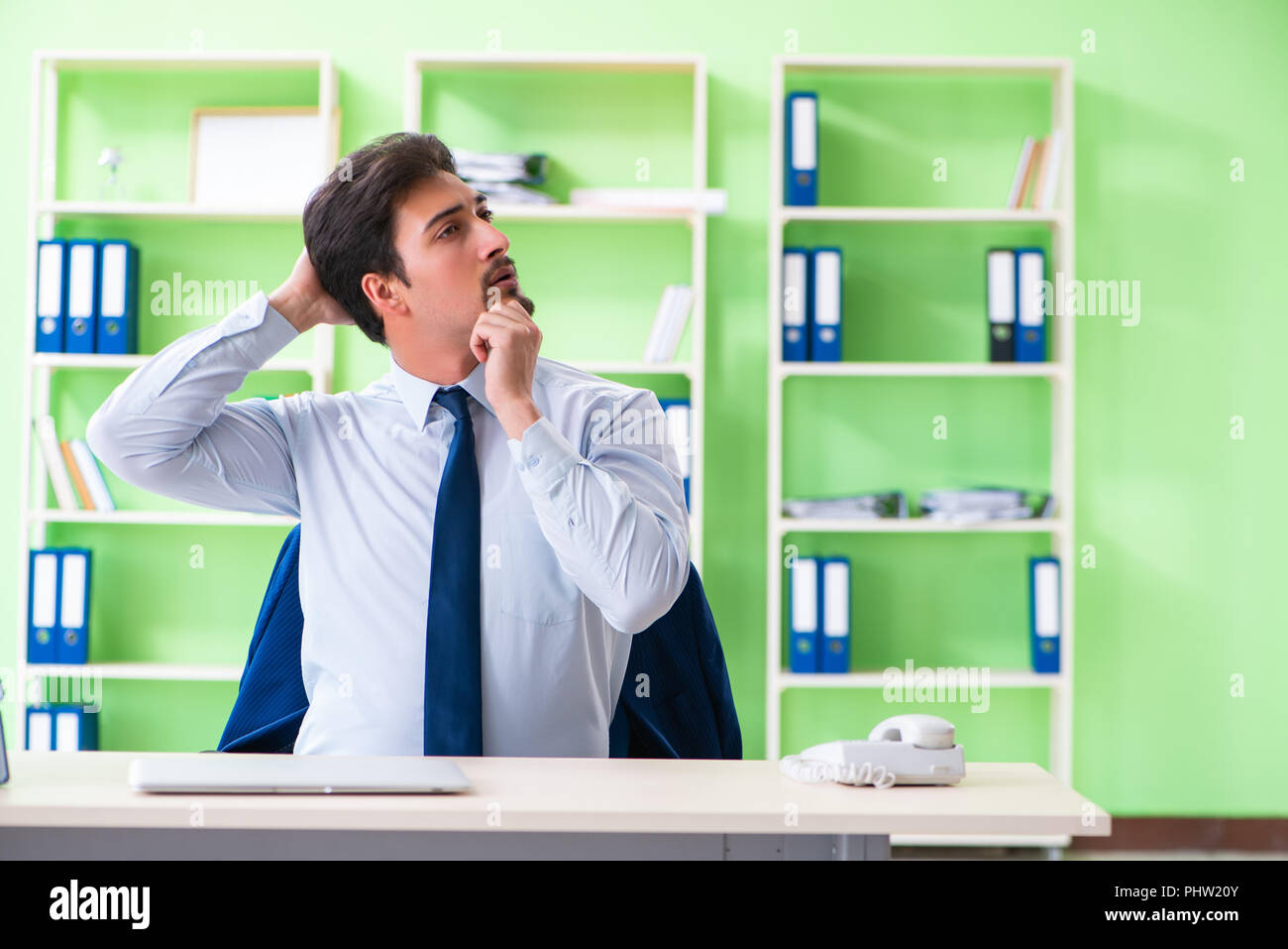 Employee doing exercises during break at work Stock Photo - Alamy