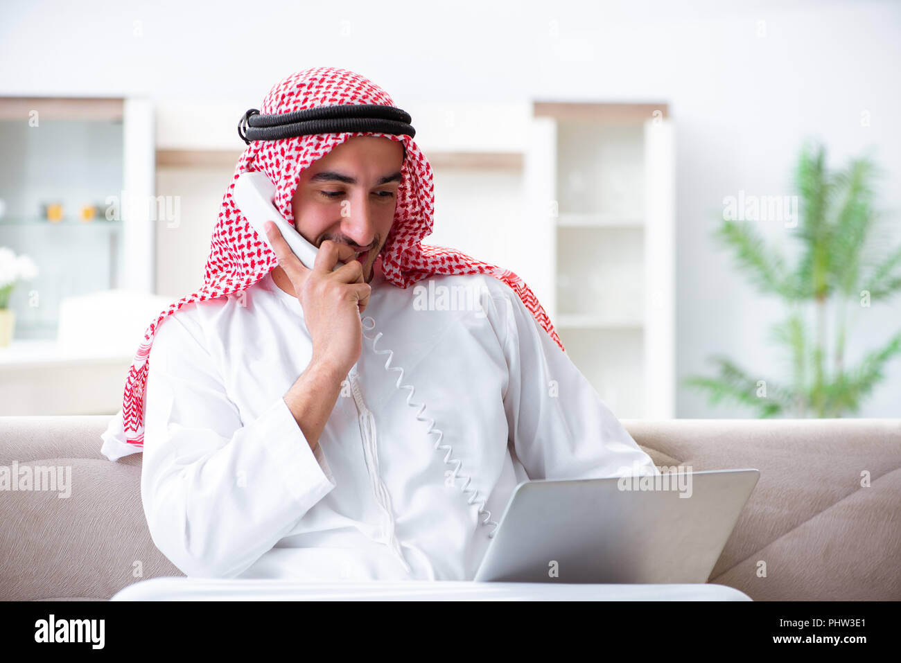 Arab man working at home on his work Stock Photo - Alamy