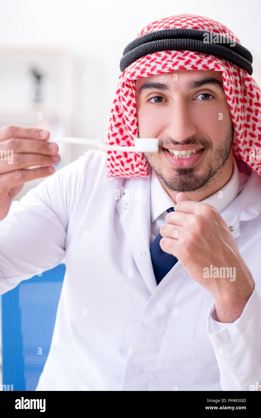 Arab dentist working on new teeth implant Stock Photo - Alamy