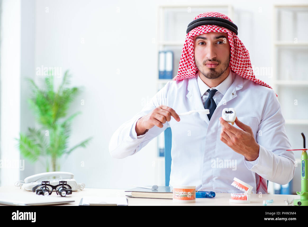 Arab dentist working on new teeth implant Stock Photo - Alamy